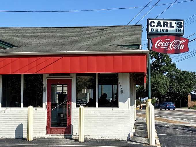 The iconic Carl's Drive-In sign stands like a beacon of burger paradise against the Missouri sky. Some landmarks never need updating.