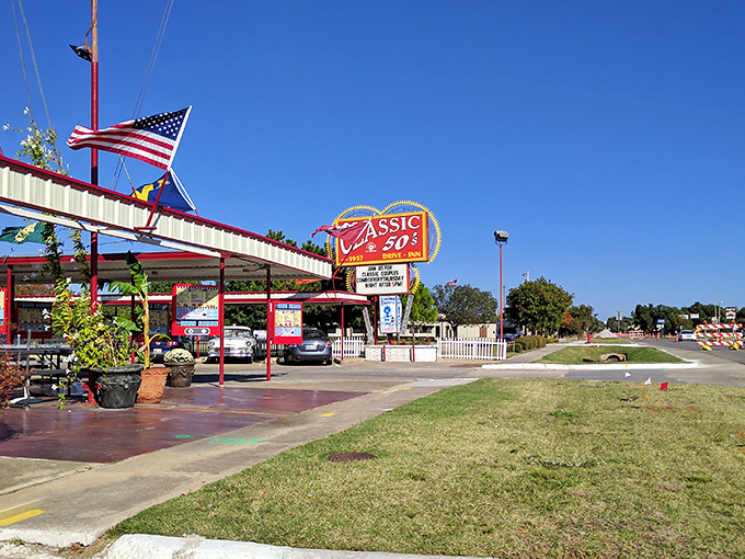 That iconic sunburst sign isn't just advertising&mdash;it's a time machine disguised as a drive-in. The red and white awning beckons like a burger beacon on the horizon.