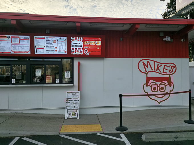 The iconic red and white exterior of Mike's Drive-In stands as a beacon of burger perfection in Milwaukie, welcoming hungry visitors with retro charm. 
