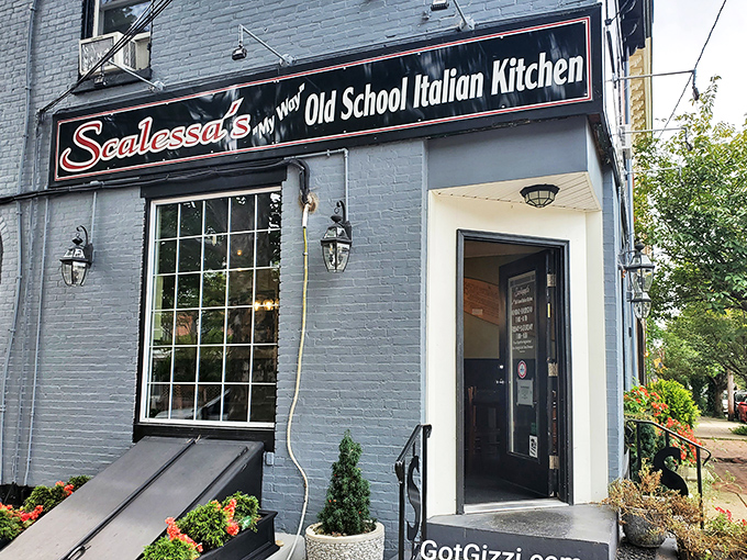 The blue-bricked charm of Scalessa's exterior, with its vibrant flower boxes and vintage lighting, promises an authentic Italian experience hiding in plain sight.