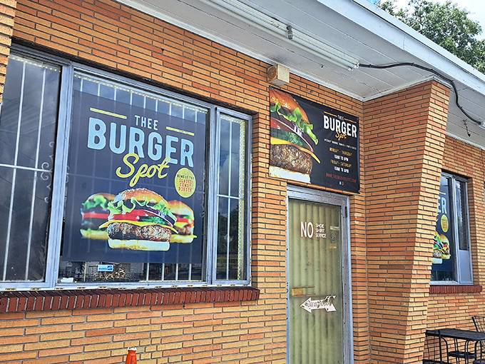 Unassuming brick exterior, colorful burger signage - Thee Burger Spot makes no architectural promises, just a humble brick declaration that burger greatness awaits within.
