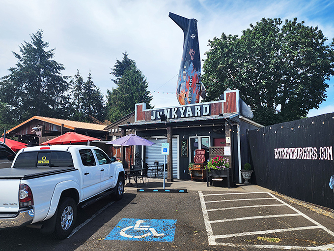 Not your average roadside stop! Junkyard's distinctive fin-shaped sign beckons hungry travelers like a burger lighthouse guiding ships to delicious shores.