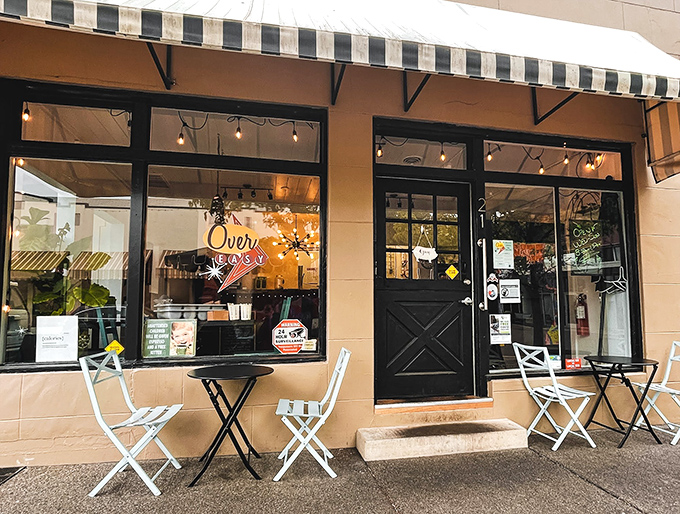 The storefront beckons with its simple charm&mdash;black door, striped awning, and outdoor seating that whispers, "Come in, the eggs are waiting." 