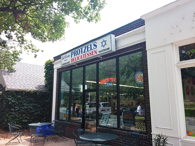 The unassuming storefront of Protzel's Delicatessen stands like a time portal to sandwich nirvana, complete with outdoor seating for those perfect St. Louis afternoons.