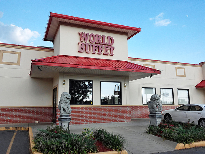 The iconic red-roofed entrance to World Buffet, where stone guardian lions stand sentinel, promising an epic feast within these hallowed walls. 