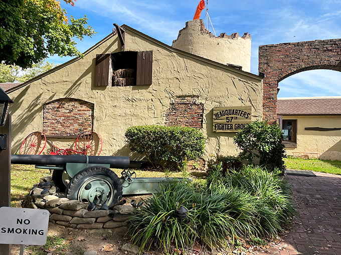 The fortress-like exterior of 57th Fighter Group stands ready for your culinary mission, complete with vintage artillery that's thankfully only targeting your appetite.