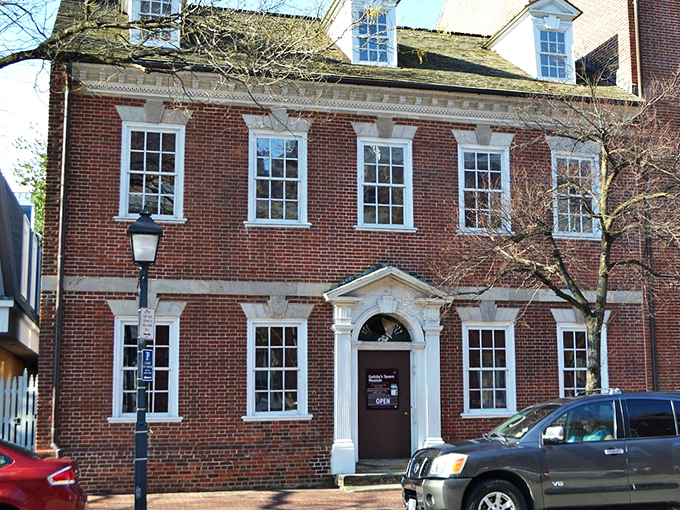The stately brick facade of Gadsby's Tavern stands proudly in Old Town Alexandria, a colonial time capsule where history and hunger harmoniously collide.