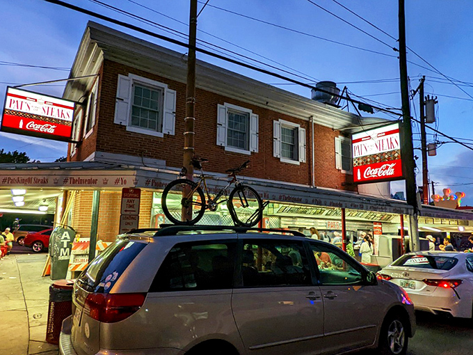 The brick-and-mortar kingdom where cheesesteak dreams come true since 1930. Pat's iconic red and white facade has witnessed nine decades of sandwich perfection.