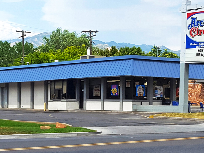 The iconic blue roof of Arctic Circle stands like a beacon of comfort food against the Utah sky, promising fry sauce nirvana within.