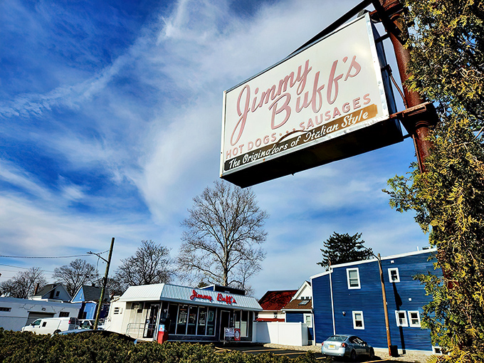 The iconic Jimmy Buff's sign stands sentinel against a perfect blue New Jersey sky, promising Italian hot dog perfection to all who approach.