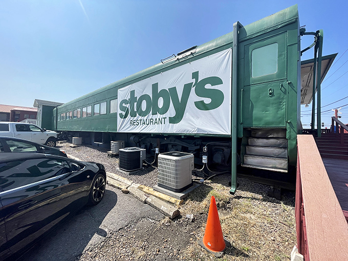 The iconic green train car of Stoby's stands proudly against an Arkansas sunset, promising culinary adventures that don't require a ticket.