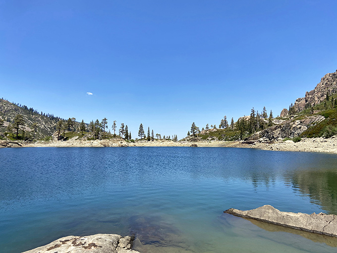 Mother Nature showing off again! Crystal blue waters mirror the majestic Sierra peaks, creating a postcard moment that no filter could improve.
