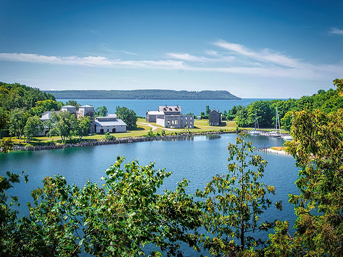 The imposing limestone blast furnaces stand like ancient temples against the azure waters of Snail Shell Harbor, a perfect marriage of industrial history and natural beauty.