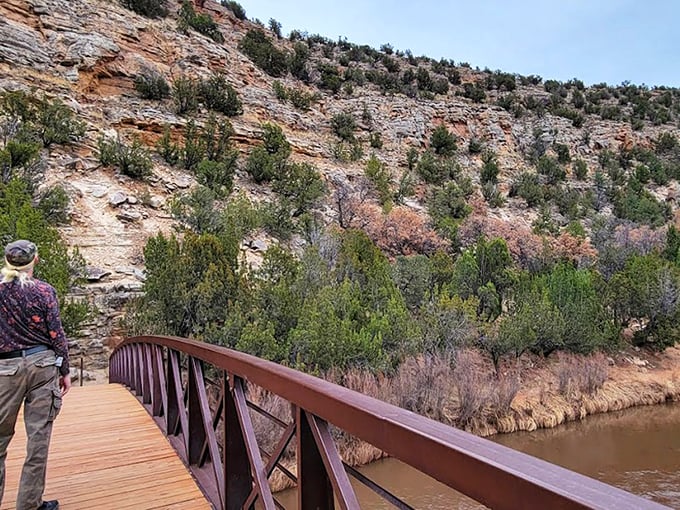 Nature's grand theater unfolds at Villanueva, where sandstone cliffs stand like ancient sentinels guarding the verdant valley below.