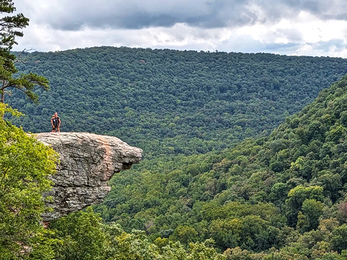 Nature's architectural remnants stand sentinel along the trail, offering glimpses of history amid the towering pines and distant valley views.