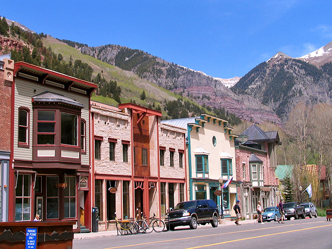 Colorado Avenue stretches toward mountain majesty, where Victorian charm meets alpine grandeur. Telluride's main street invites you to wander and wonder.