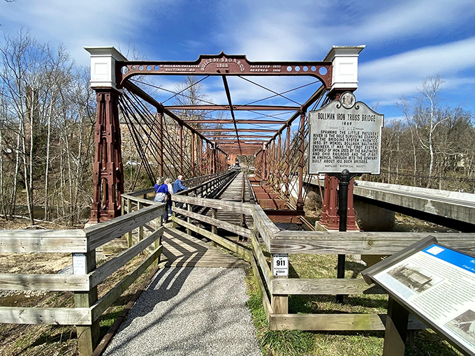 The historic Bollman Truss Bridge stands as an iron sentinel over time, its burgundy framework a perfect backdrop for selfies that'll make your Facebook friends jealous.