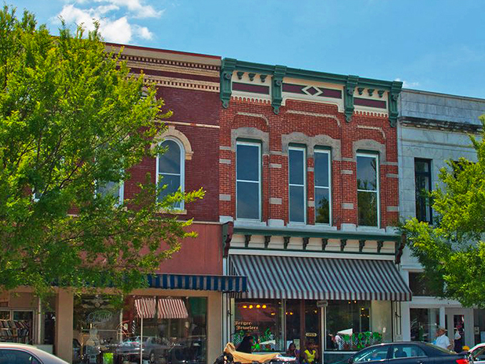 Thomasville's historic downtown facades stand like colorful sentinels of bygone eras, where modern cars park alongside timeless architecture. 