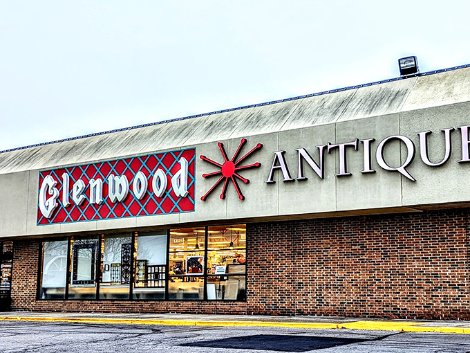 The iconic red and blue sign of Glenwood Antique Mall stands as a beacon to treasure hunters. Like a portal to the past, this unassuming exterior hides a universe of wonders within.