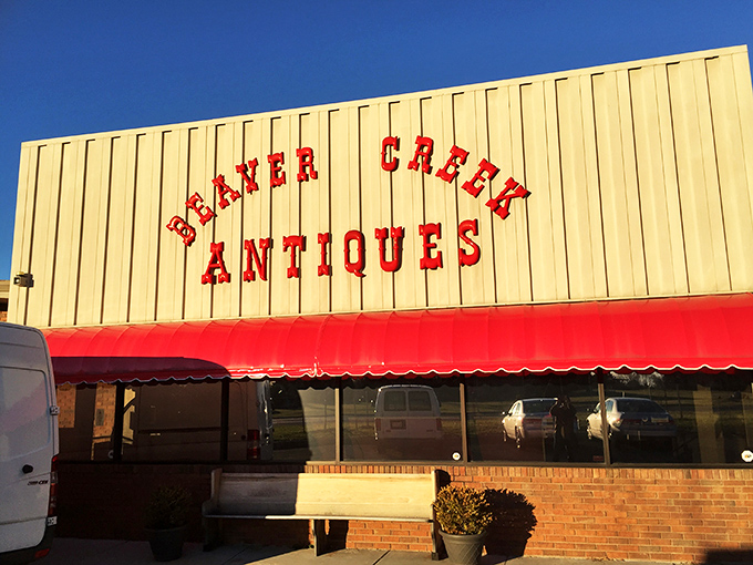 The unassuming exterior of Beaver Creek Antique Market proves that judging books by covers is a rookie mistake. Treasures await behind that bold red signage.