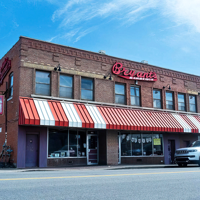 The iconic brick facade and bold red sign of Arthur Bryant's stands as a beacon of barbecue excellence against the Kansas City sky.