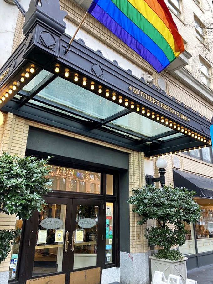 The corner storefront beckons like an old friend, promising comfort with its elegant awning and warm glow from within. Portland's downtown treasure awaits