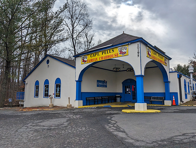 The blue and white exterior of Captain Pell's stands like a maritime beacon in suburban Fairfax, promising seafood treasures within. No pretension, just delicious anticipation.