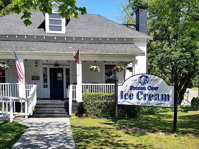 Home sweet ice cream home! This picture-perfect white farmhouse with its inviting porch practically whispers "slow down and treat yourself" to every passerby.