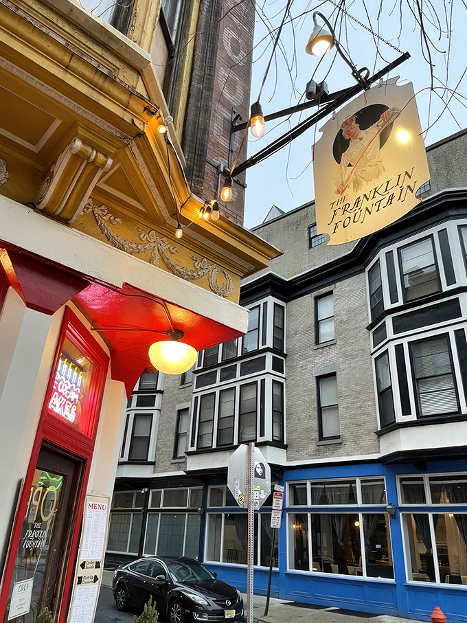 The storefront beckons like a time portal to ice cream's golden age&mdash;ornate yellow cornice, classic signage, and that brick facade promising sweet nostalgia inside.