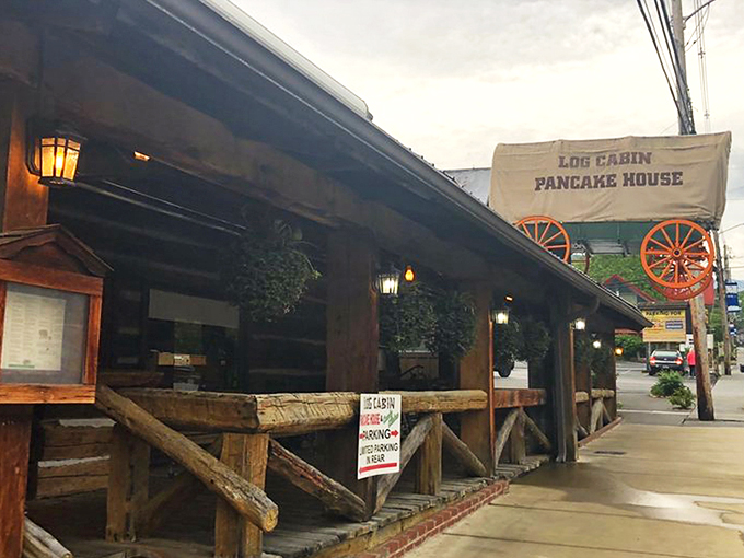 The iconic covered wagon sign welcomes hungry travelers like a beacon of breakfast hope on Gatlinburg's bustling parkway.