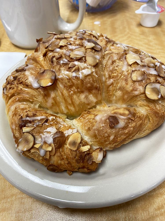 This almond croissant isn't just pastry&mdash;it's architecture. Layers upon flaky layers creating a buttery fortress protecting treasure inside. Worth every crumb.
