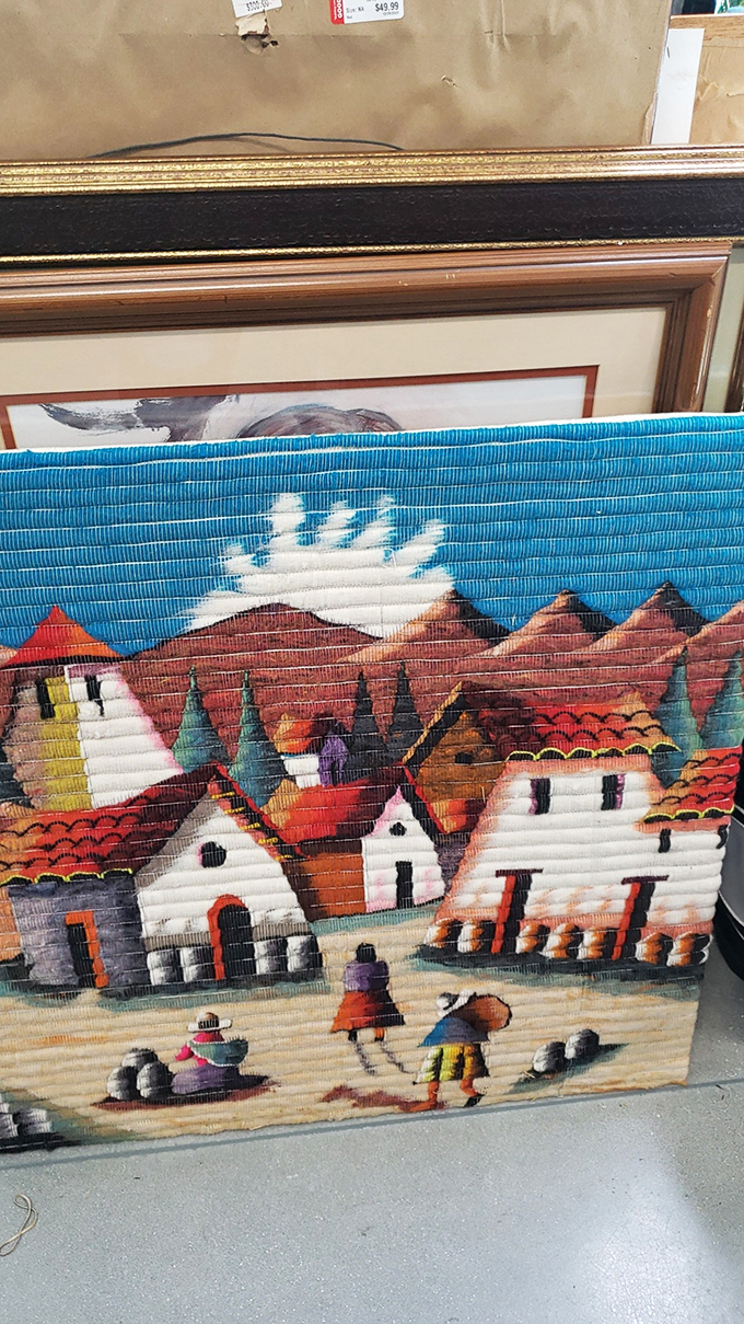 This vibrant textile artwork depicting a mountain village brings international flair to the home d&eacute;cor section. Someone's wall is waiting.