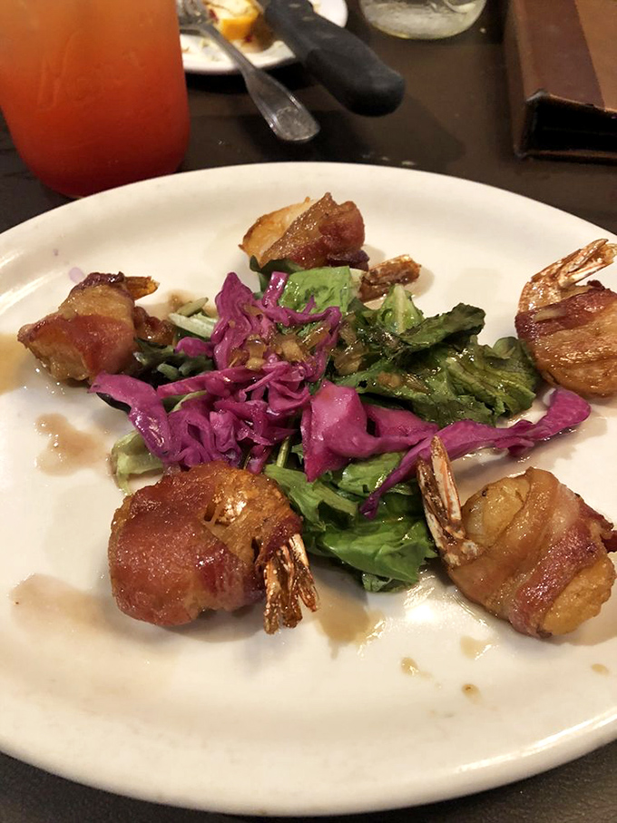 Bacon-wrapped shrimp perched atop a colorful salad&mdash;proof that surf, turf, and garden can coexist in perfect harmony.