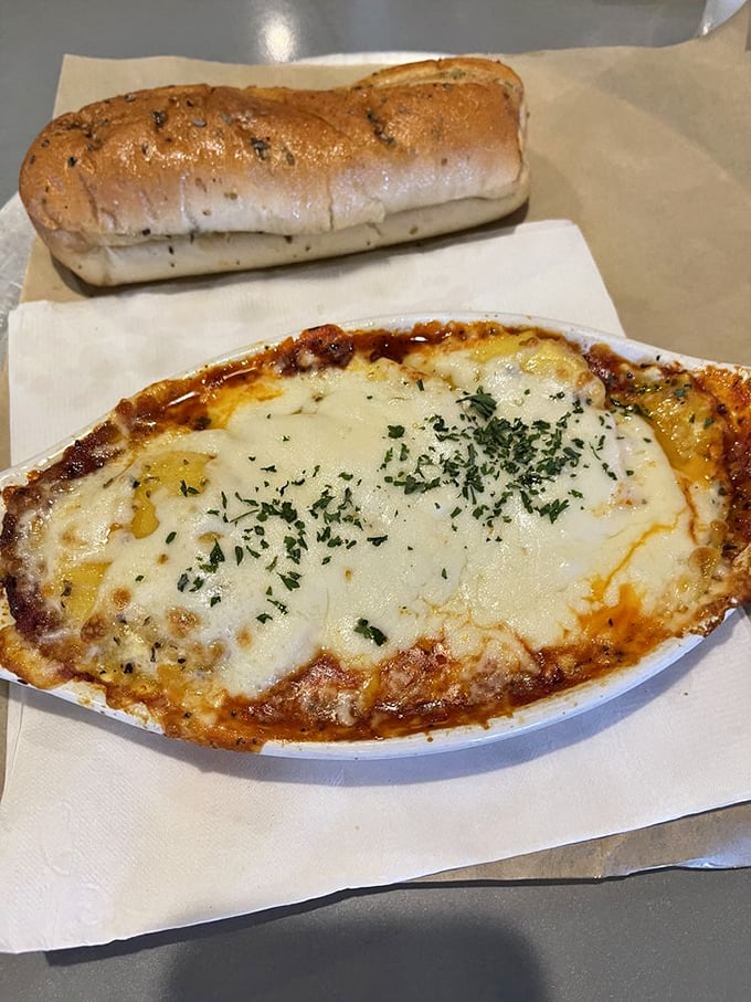 The baked ravioli arrives bubbling like a delicious lava pool of cheese with that garlic bread poised for the perfect rescue mission.