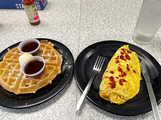 Belgian waffles and omelets sharing a plate like old friends, proving that breakfast should never force you to make difficult decisions.
