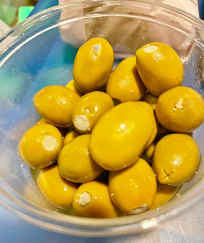 These aren't just olives—they're little green flavor bombs waiting to elevate your antipasto platter from good to "where have these been all my life?"