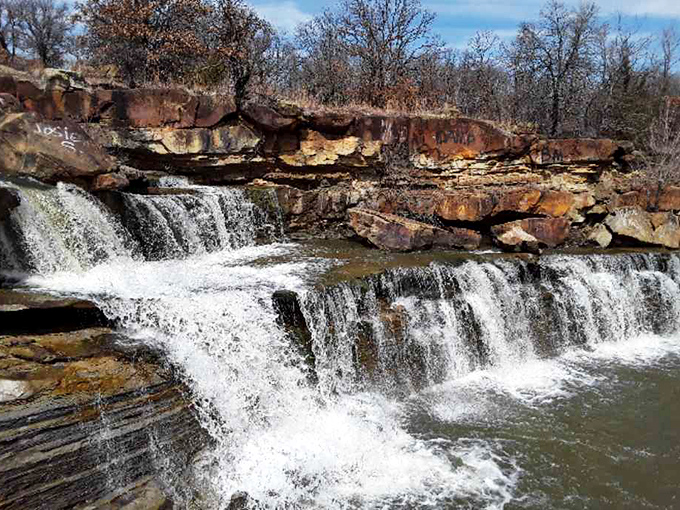Bluestem Falls cascades over ancient rock formations, creating nature's version of a spa day&mdash;minus the cucumber water and hefty bill.
