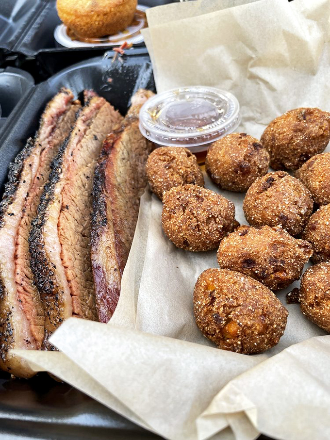 Brisket sliced thin enough to read through, paired with hush puppies that would make a Southerner weep with joy. Comfort food elevated to art form. 