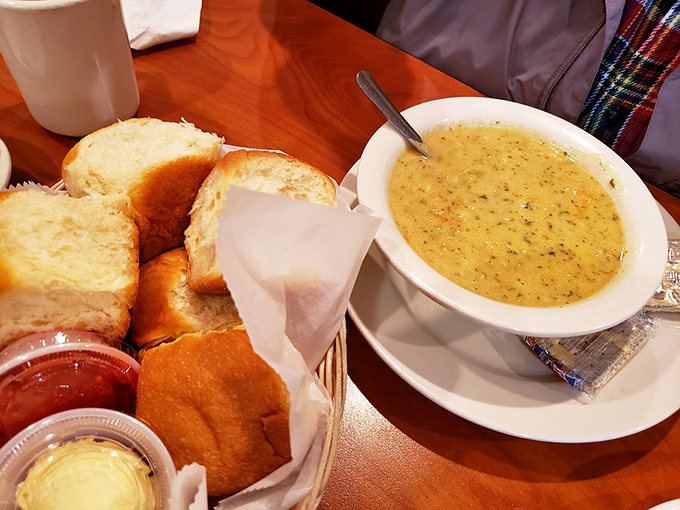 A basket of biscuits that deserve their own fan club, alongside soup that proves vegetables and cheese were meant for each other.