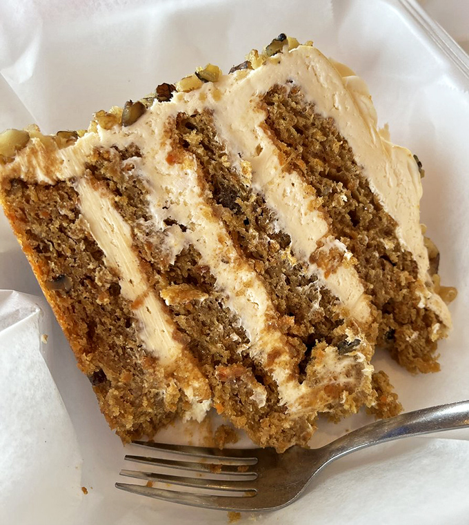 Four magnificent layers of carrot cake that could make even non-dessert people reconsider their life choices. Those walnuts are the supporting actors.
