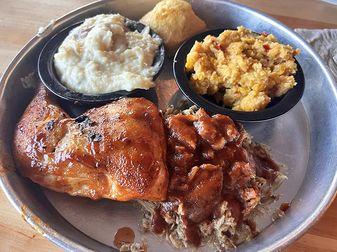 Chicken and pulled pork sharing a plate like old friends at a reunion. That cornbread cube? The perfect mediator.