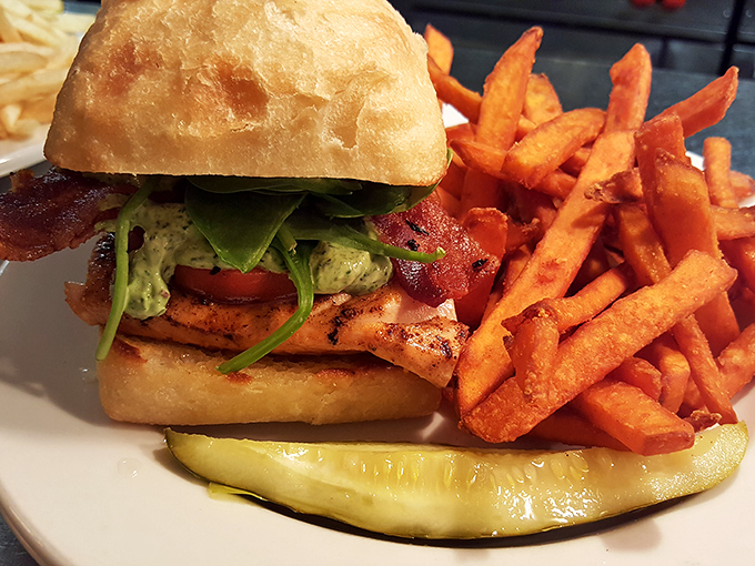 A sandwich architecture so perfect it deserves its own blueprint. Those sweet potato fries could make regular fries develop an inferiority complex.