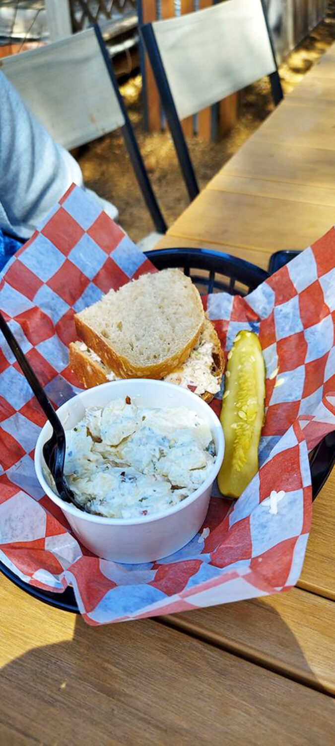 The potato salad and pickle aren't just sides—they're supporting actors deserving of their own standing ovation. That sandwich is the undisputed star.