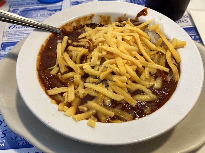 A bowl of chili crowned with a blizzard of melted cheese&mdash;winter comfort that warms you from the inside like a culinary hug.