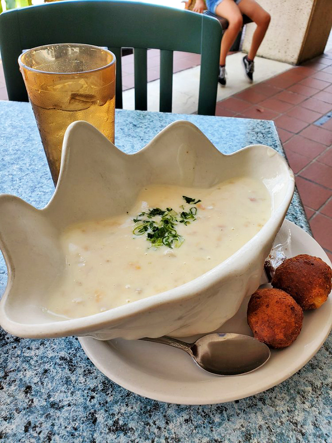 A seashell bowl of creamy clam chowder with hushpuppy companions. Neptune himself would approve of this oceanic comfort. 