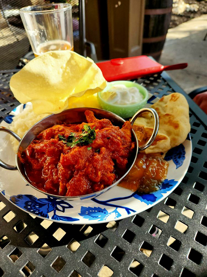 Their chicken curry arrives in its own little copper pot, like a spicy treasure chest that's been unlocked just for you.