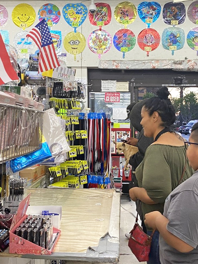 Shoppers browse the party supply section with the focus of treasure hunters. That look of discovery when you find exactly what you didn't know you needed.