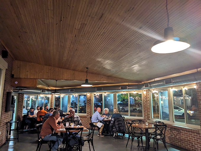 Evening diners bask in the warm glow of pendant lights, creating that magical dinner hour when conversations flow as smoothly as the barbecue sauce.