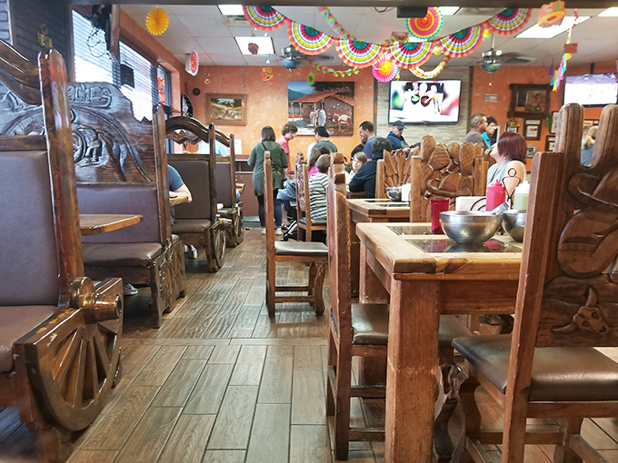 Colorful papel picado decorations hang overhead as diners engage in the universal language of "this is so good I can't talk right now."
