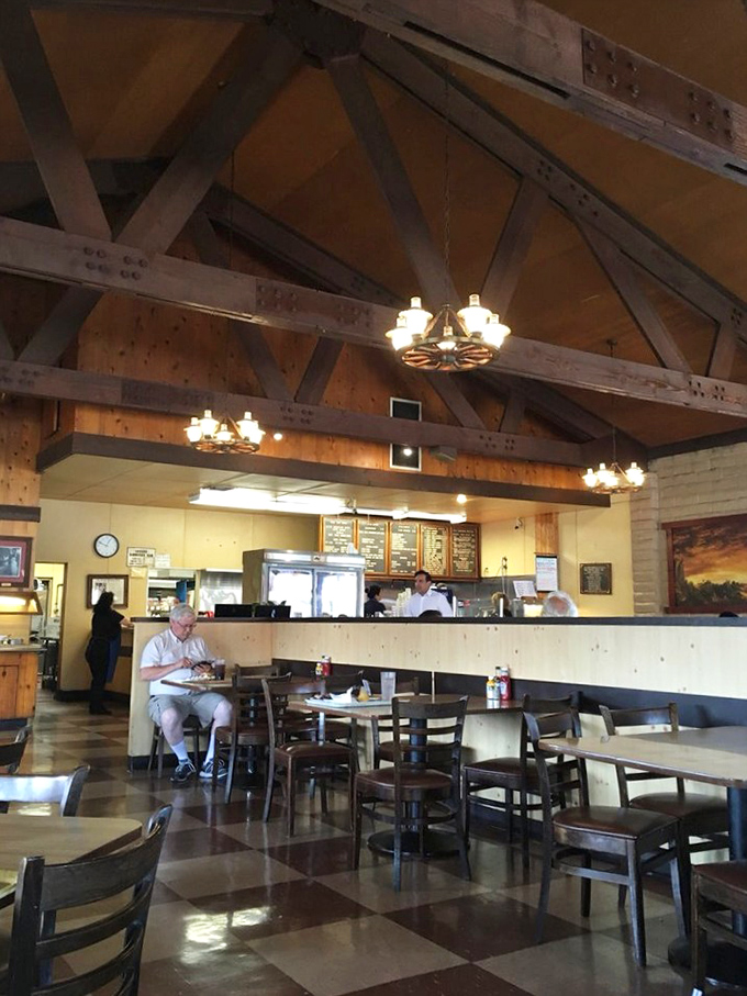 High wooden beams frame a scene of pure contentment. This isn't just eating; it's a communal ritual where strangers become friends over shared barbecue bliss.